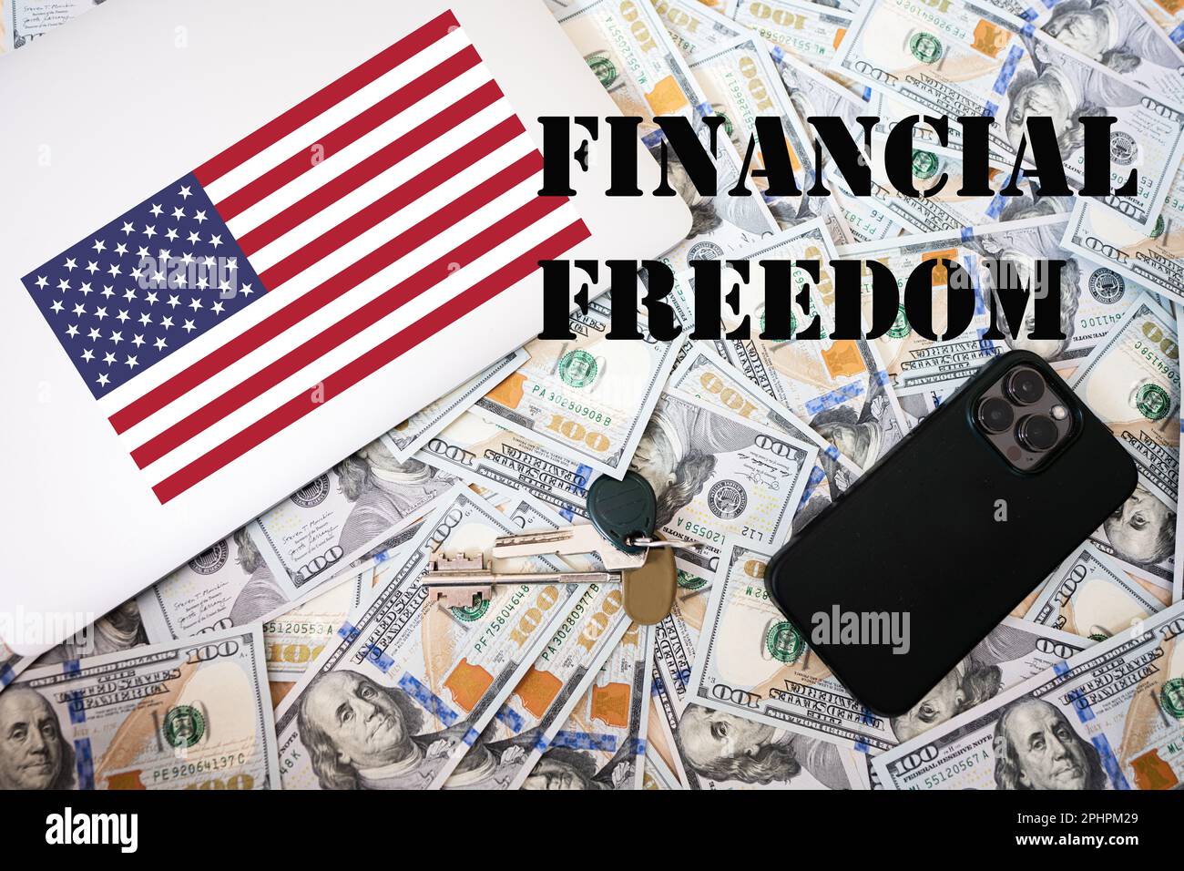 Financial freedom concept. USA flag, dollar money with keys, laptop and ...