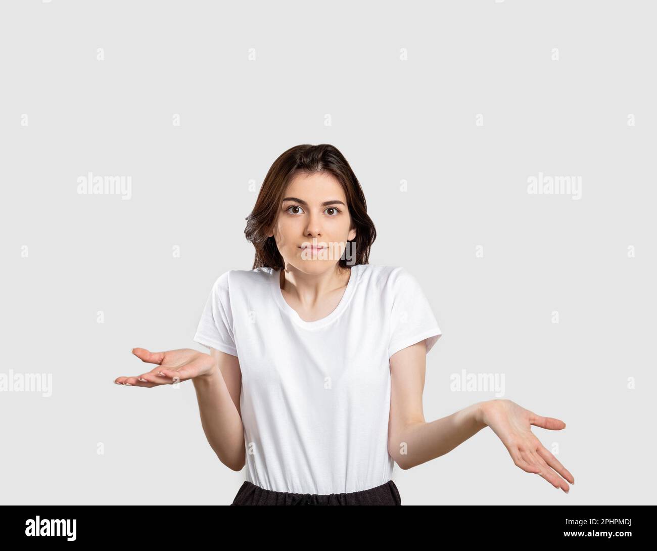 shrug gesture confused woman raising shoulders Stock Photo - Alamy
