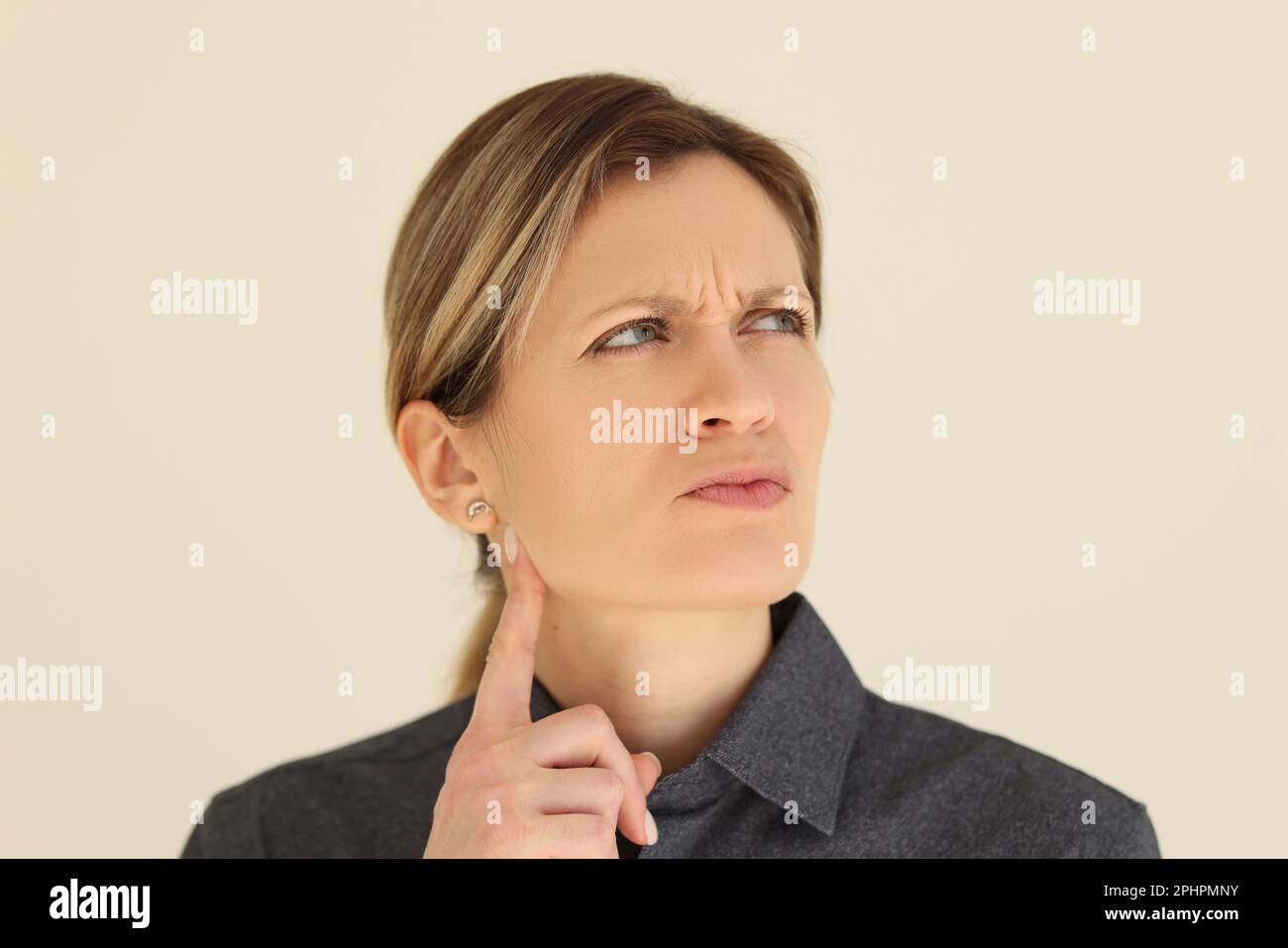 Woman thoughtful expression touches hi-res stock photography and images ...