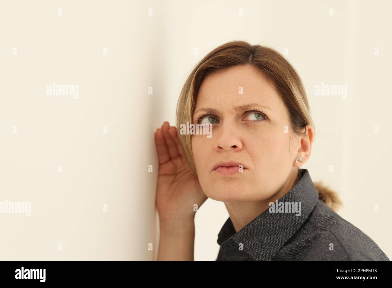 Curious woman listens to discussion of friends in kitchen Stock Photo ...