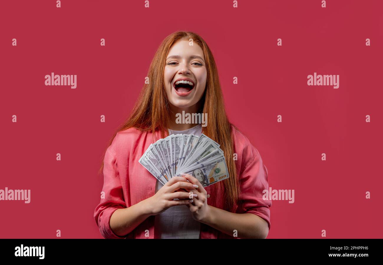 Rich excited ginger woman with cash money USD currency dollars ...
