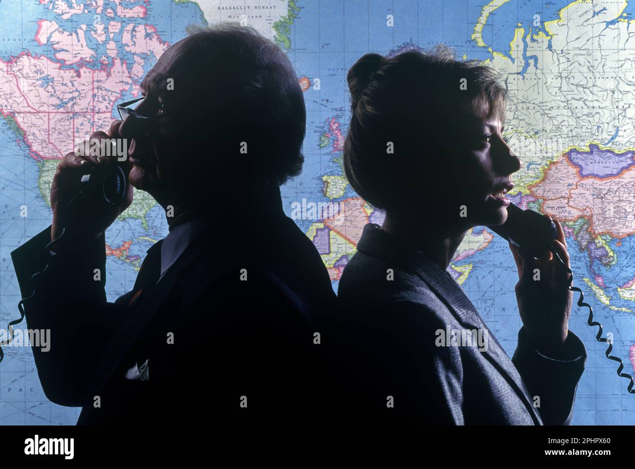 1990 HISTORICAL SILHOUETTED OFFICE WORKERS STANDING WITH TELEPHONES AT ...