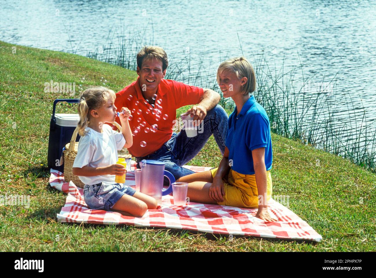 1990 HISTORICAL FAMILY TOGETHER OUTSIDE ON PICNIC BY LAKE Stock Photo ...