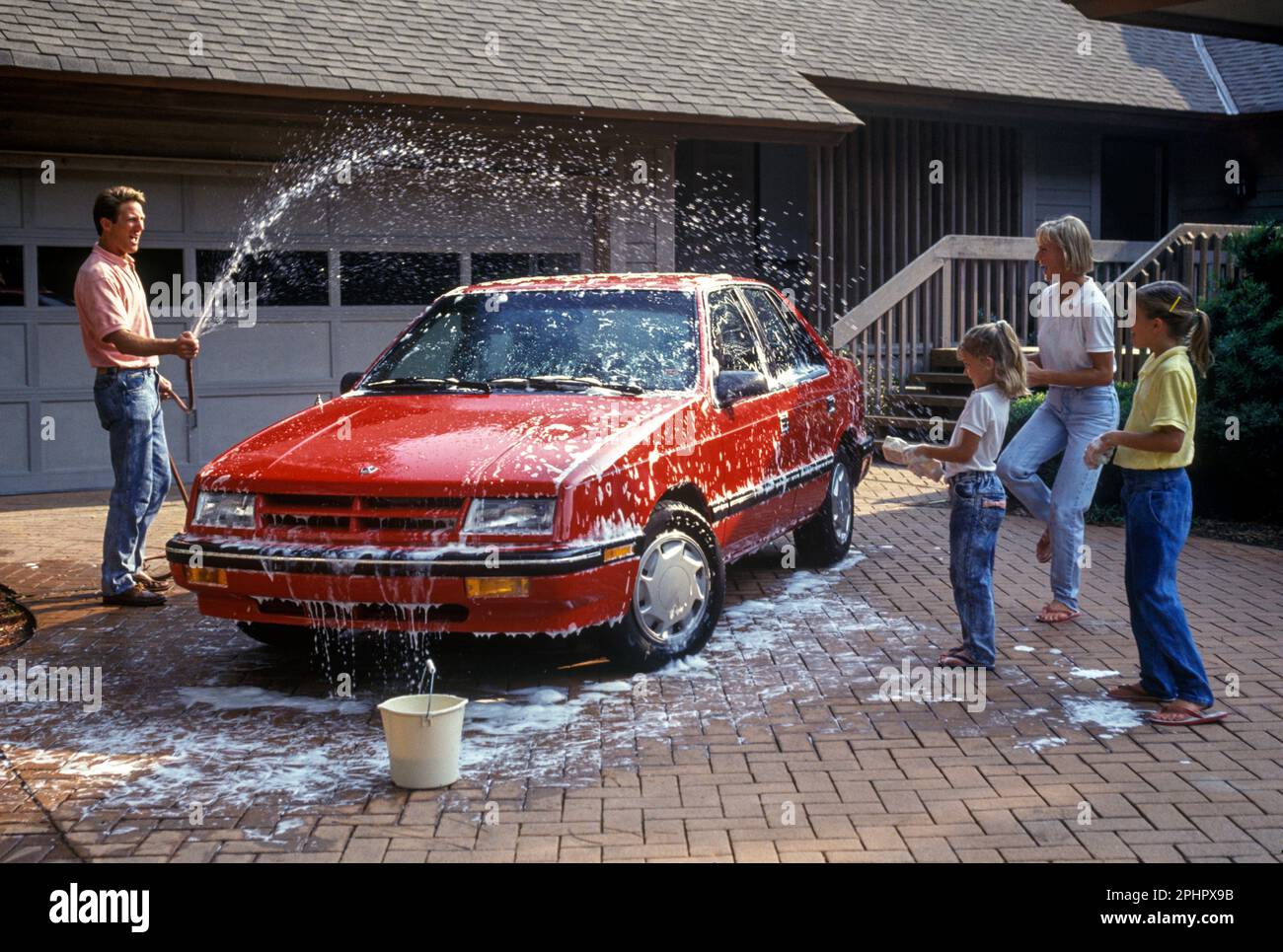 1990 HISTORICAL FAMILY TOGETHER WASHING RED AUTOMOBILE (©CHRYSLER CORP ...