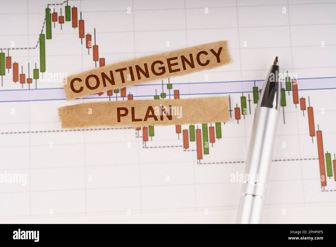 Business concept. On the chart of business quotes lies a pen and torn ...