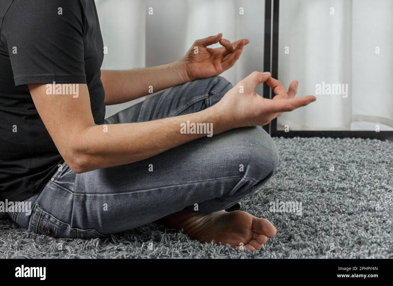 A man meditates in the lotus position. Close-up Stock Photo - Alamy