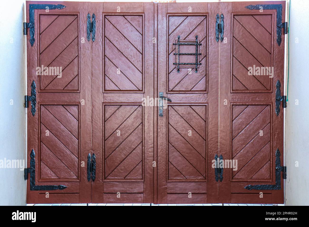 Barred window of brown painted old wooden monastery gate Stock Photo ...