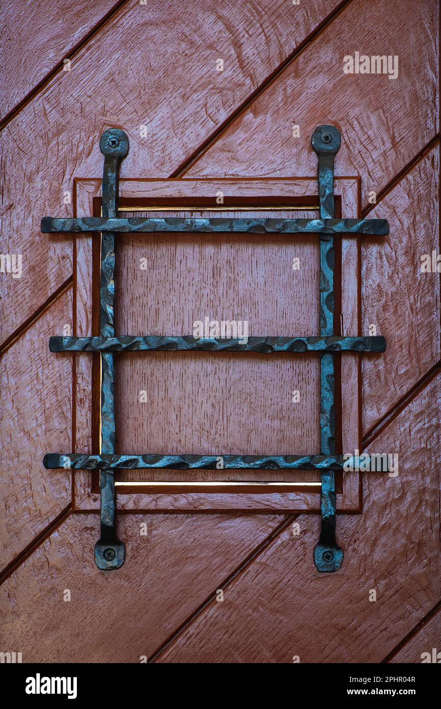 Brown painted old wooden monastery gate with barred window Stock Photo ...