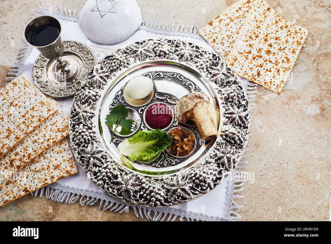 Composition with symbolic Passover, Pesach, items and meal on stone ...