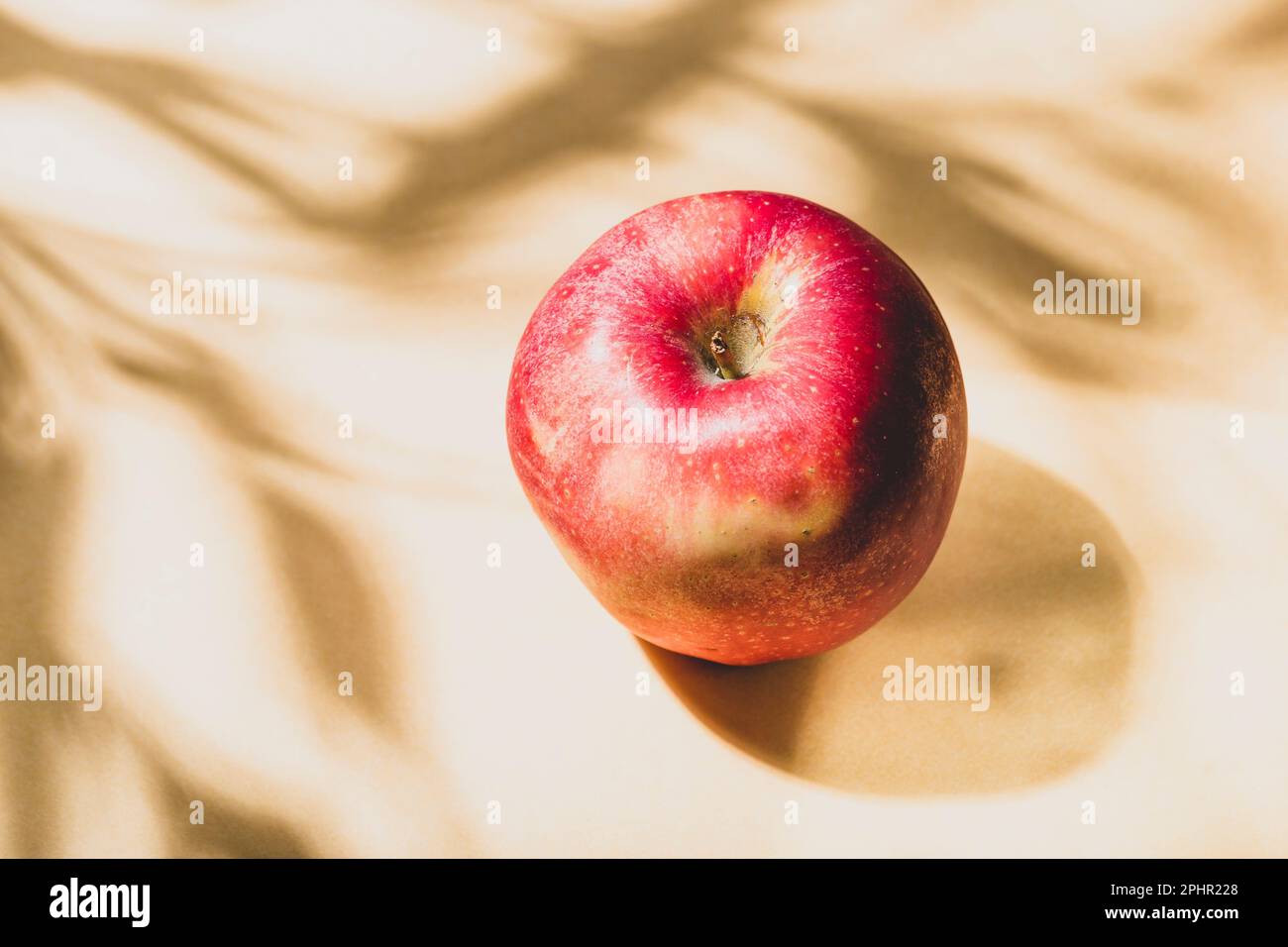 one red apple on a yellow background, view from above Stock Photo - Alamy