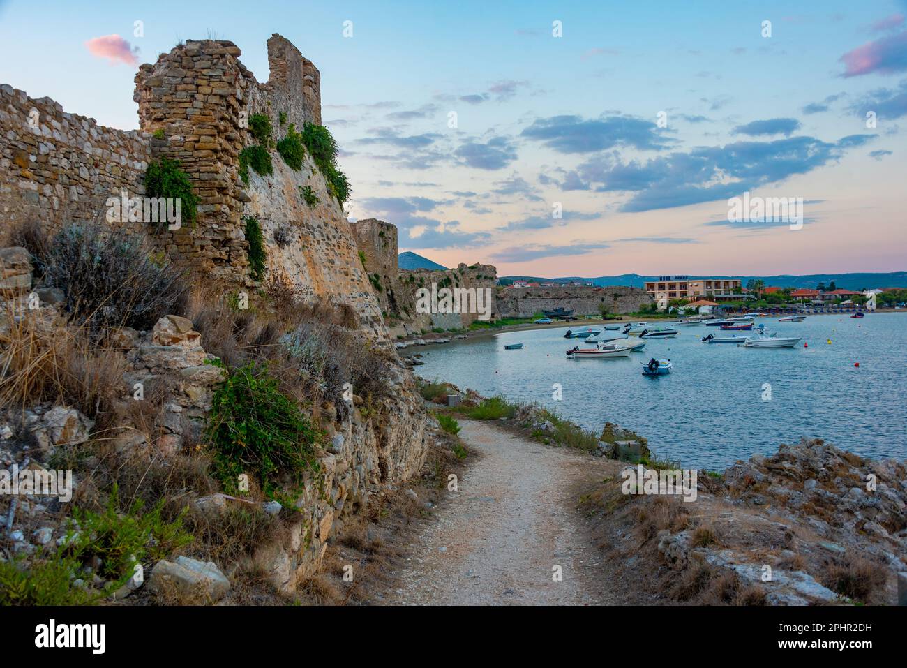 Sunset view of boats mooring alongside Methoni castle in Greece Stock ...