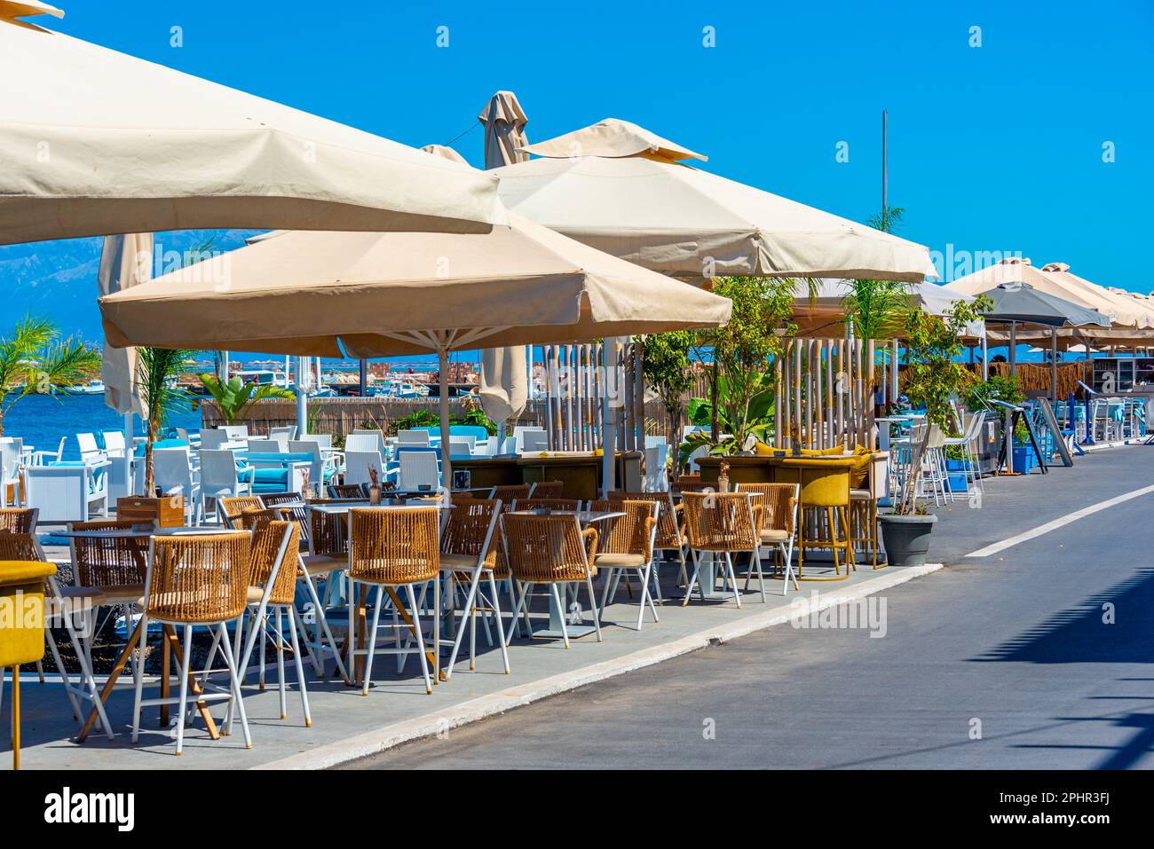 Seaside promenade at the port of Koroni in Greece Stock Photo - Alamy
