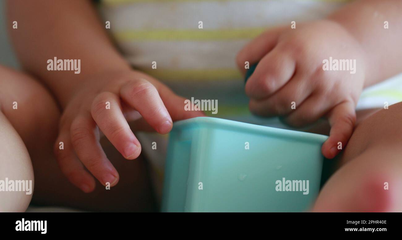 Closeup of baby hands snacking, infant toddler hand grabbing fruit ...