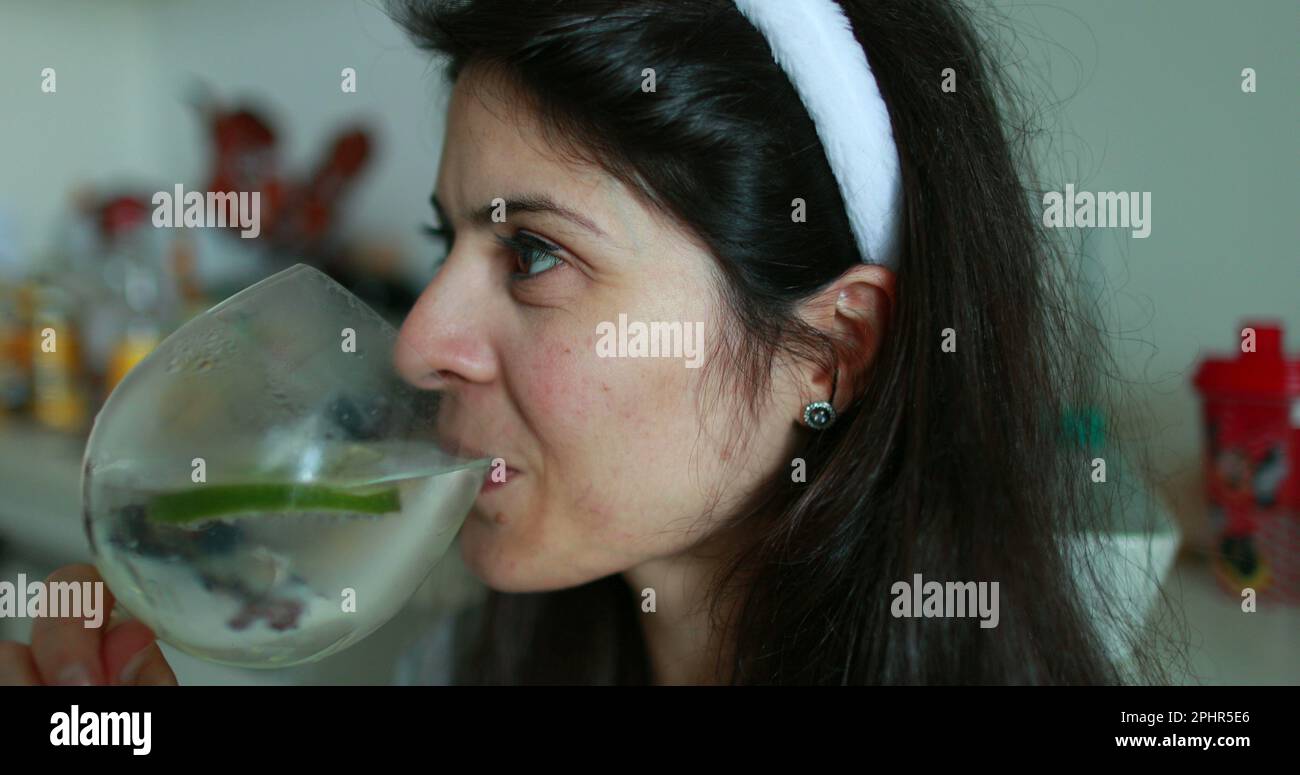 Casual Woman Taking A Sip Of Gin And Tonic Drink Woman In 30s Drinking