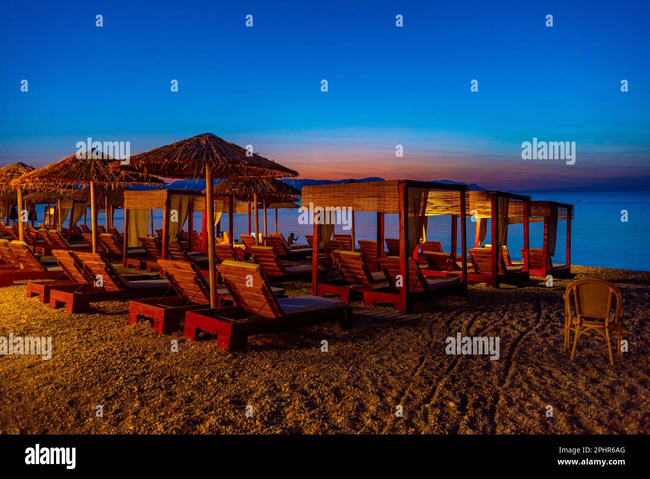 Sunset view of a beach in Loutraki, Greece Stock Photo - Alamy