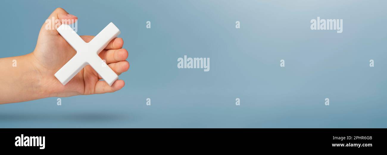 White multiplication symbol or cross in hand. The concept of ...