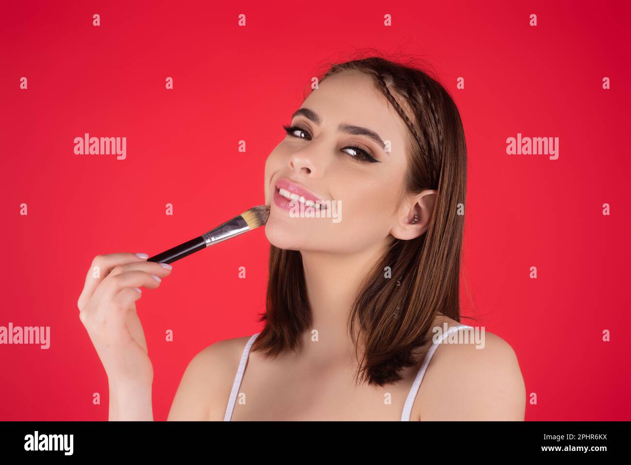 Girl hold blush blusher apply powder visage isolated over studio ...