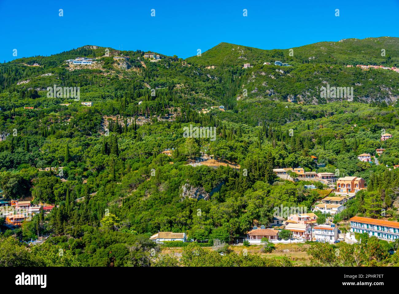 Mountains overlooking Greek resort town Palaiokastritsa at Corfu island ...