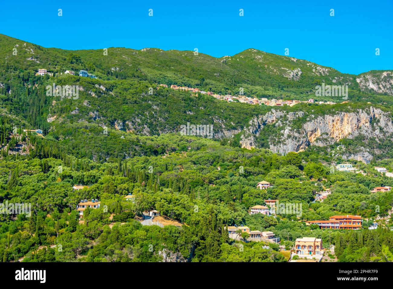 Mountains overlooking Greek resort town Palaiokastritsa at Corfu island ...