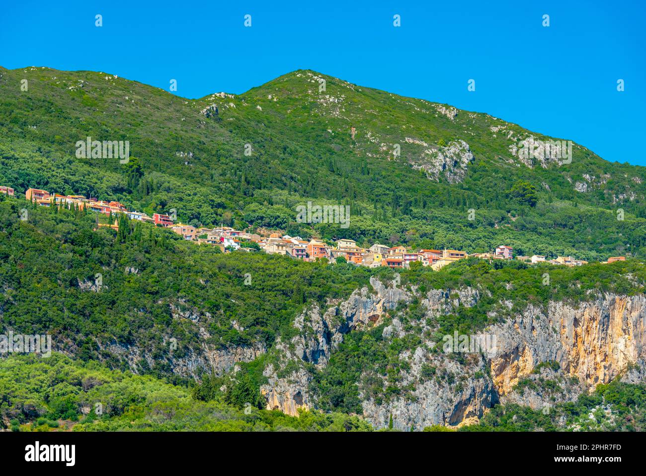 Mountains overlooking Greek resort town Palaiokastritsa at Corfu island ...