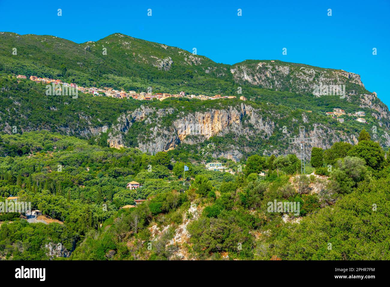 Mountains overlooking Greek resort town Palaiokastritsa at Corfu island ...