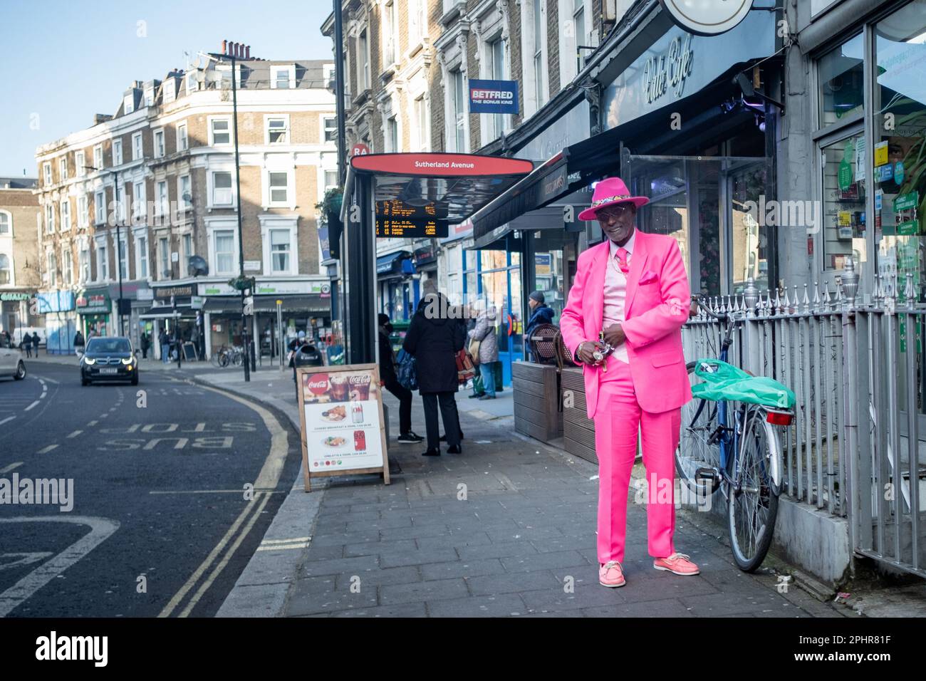 London- January 2023: A man wearing a pink suit on Harrow Road W9 west ...