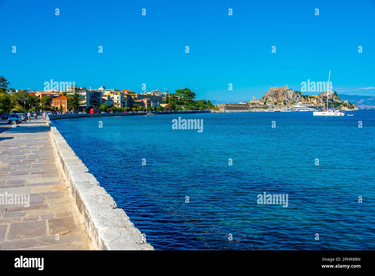 View of the Palaio Frourio at the far end of waterfront promenade at ...