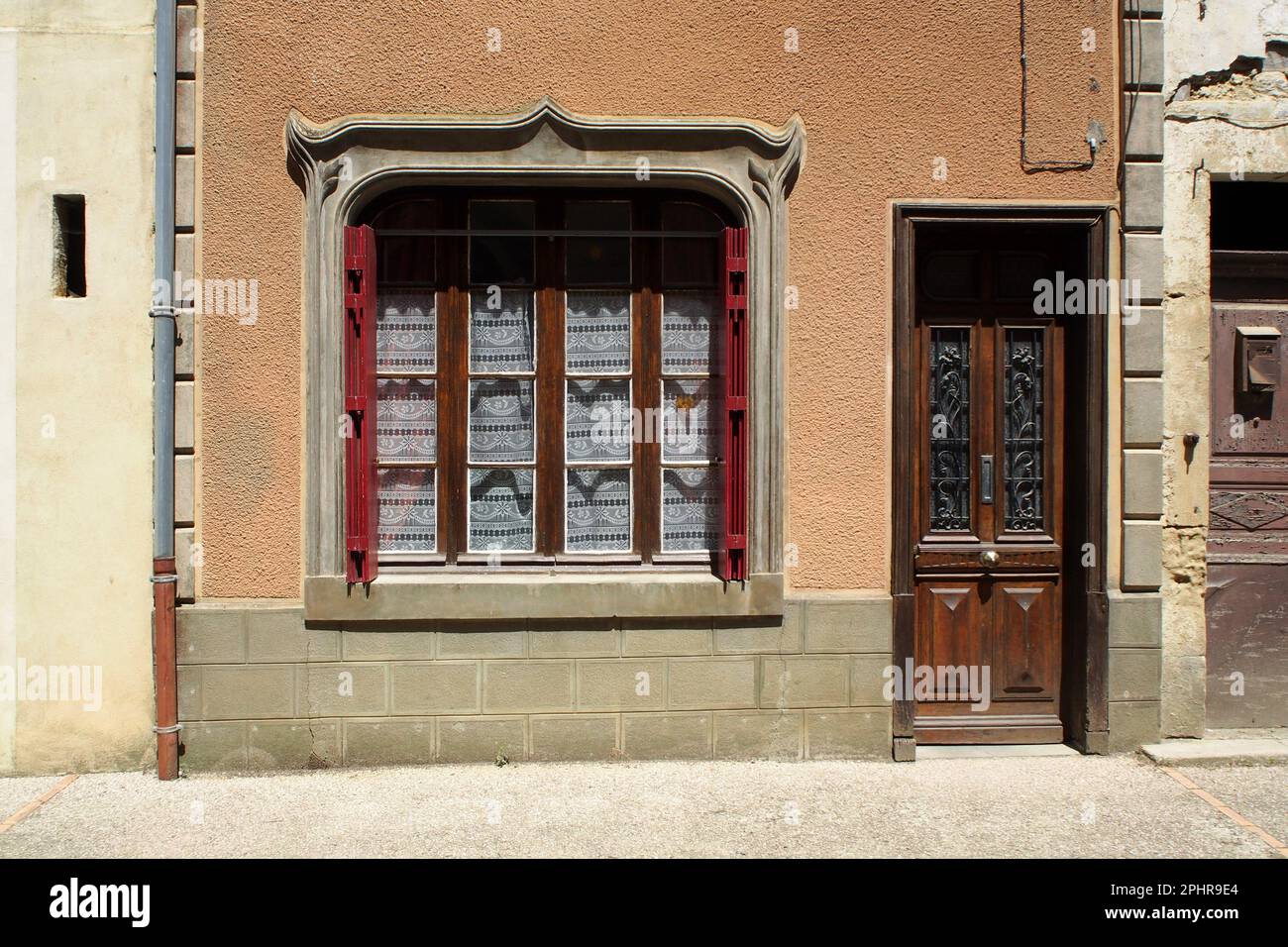Window with traditional lace curtains and a door of a vintage townhouse ...