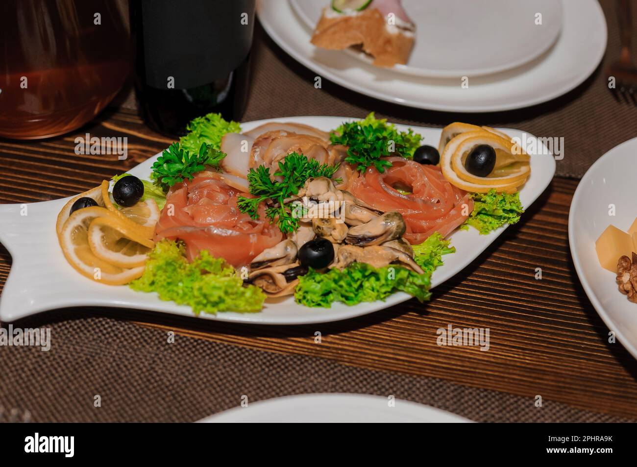 Slicing different types of red and white fish on a buffet table ...