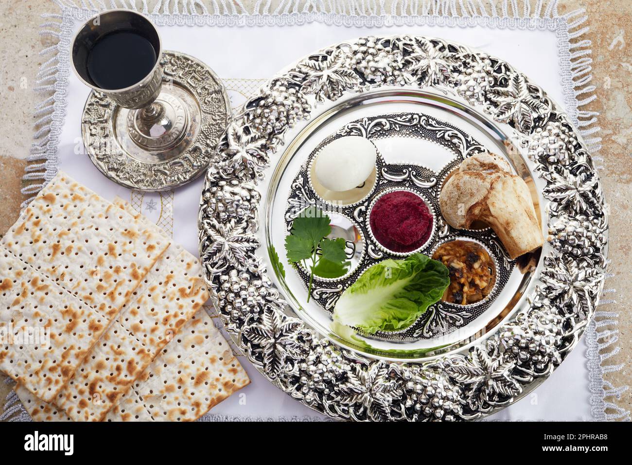 Composition with symbolic Passover, Pesach, items and meal on stone ...