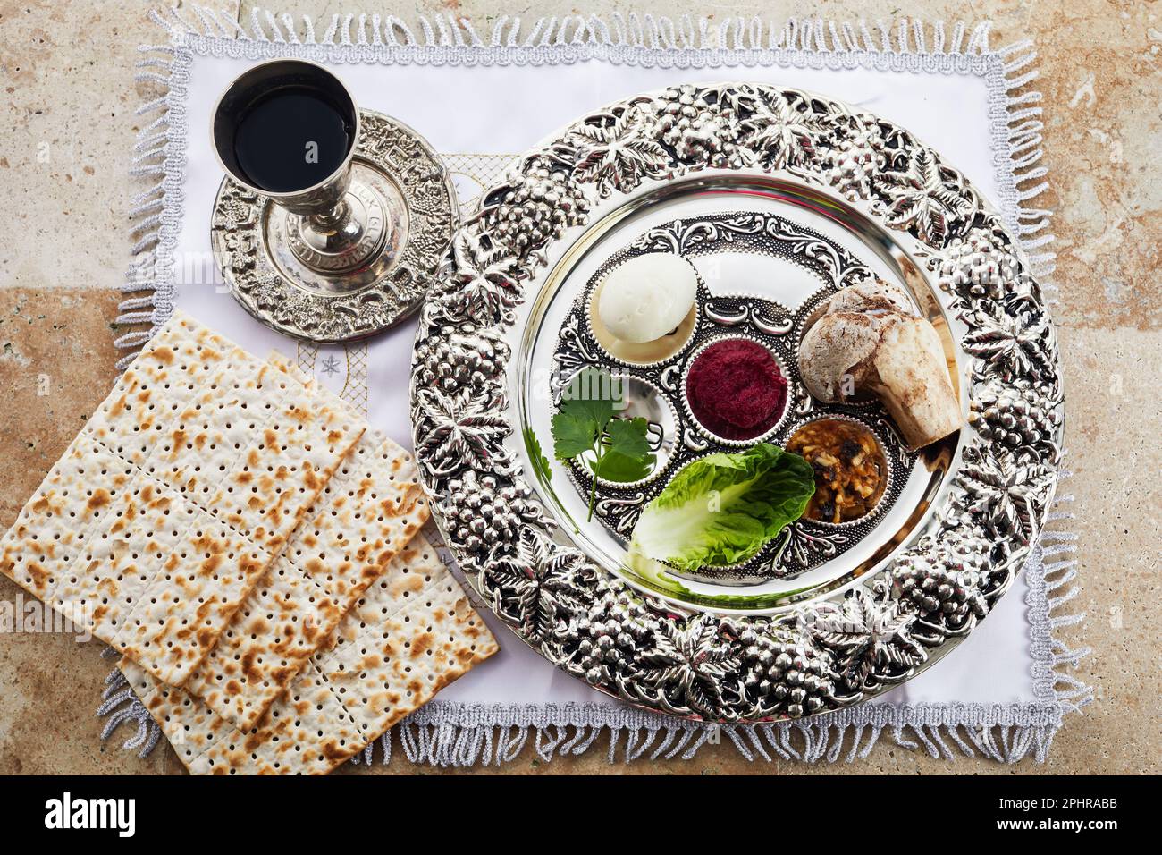 Composition with symbolic Passover, Pesach, items and meal on stone ...