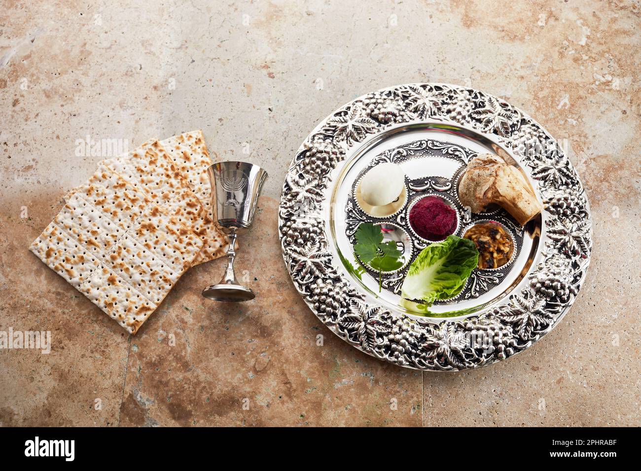 Composition with symbolic Passover, Pesach, items and meal on stone ...