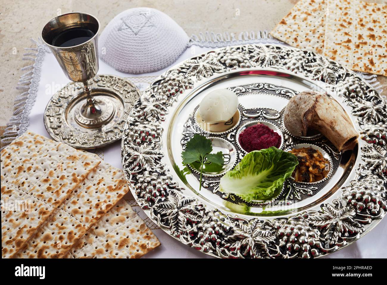 Composition with symbolic Passover, Pesach, items and meal on stone ...