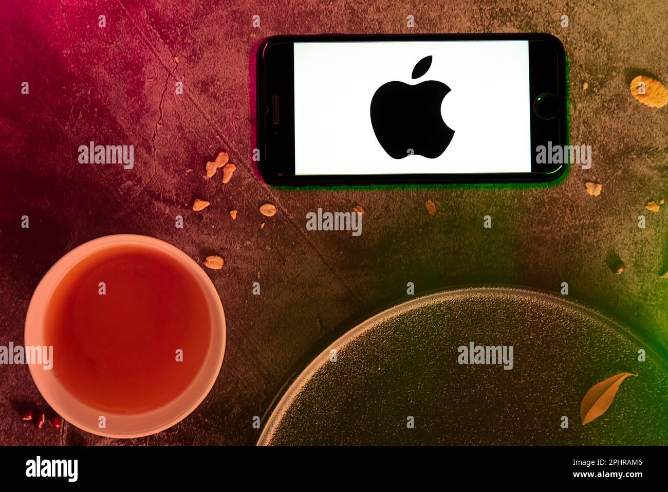 In this photo illustration, the Apple logo is seen displayed on a ...