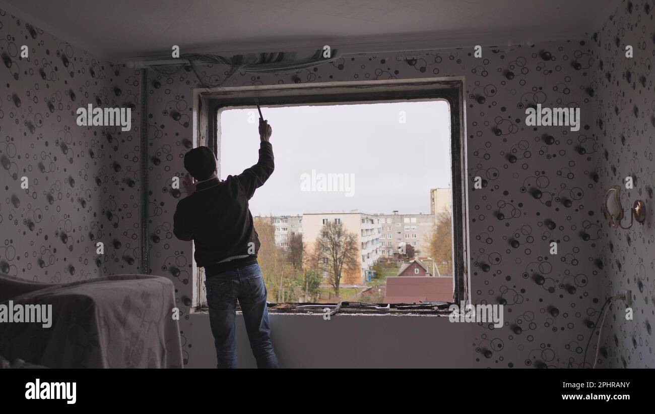 An employee removes an old wooden window Stock Photo - Alamy