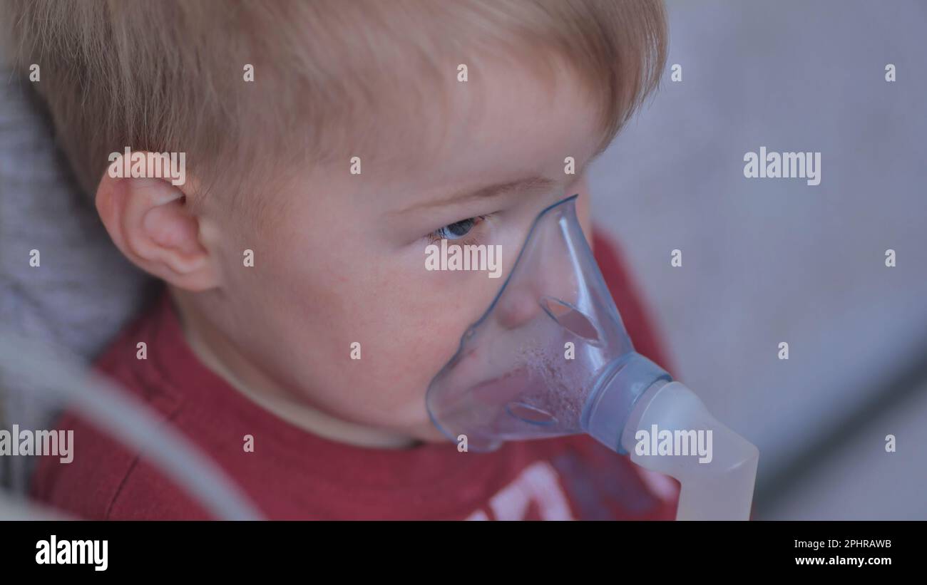 Funny boy breathing through an inhaler mask Stock Photo - Alamy