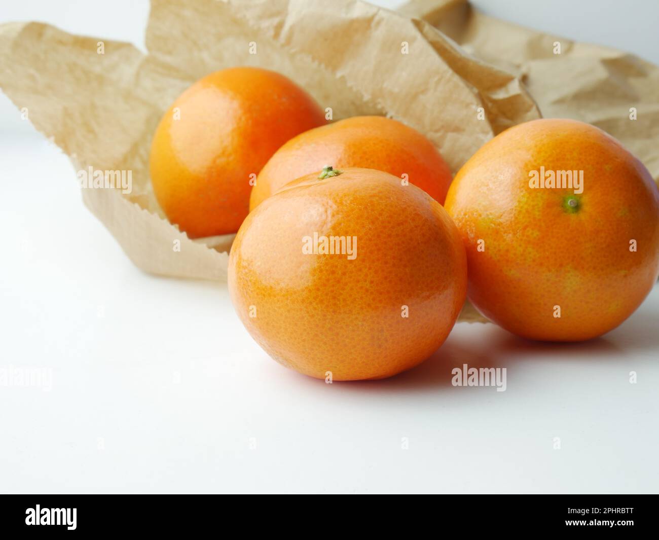 An image of a collection of four ripe oranges on a kitchen countertop ...