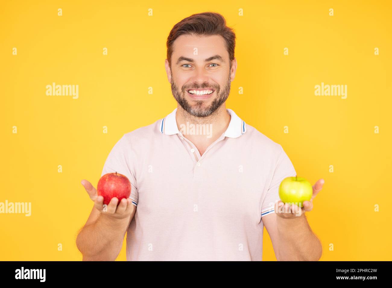 Stomatology concept. Man with perfect smile holding apple on studio ...
