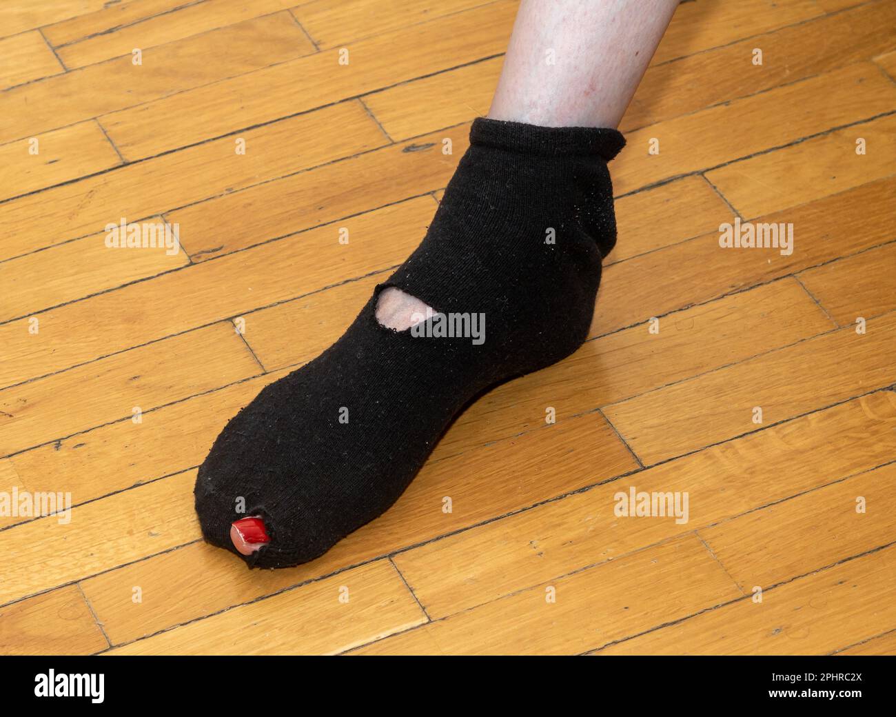 Destroyed torn old sock on female foot with toe sticking out Stock ...