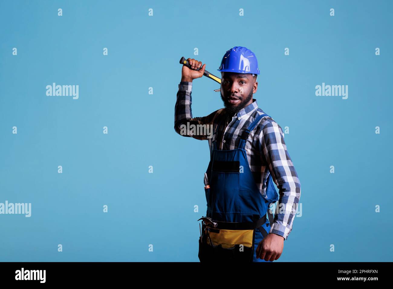 African american construction worker aggressively holding hammer ...