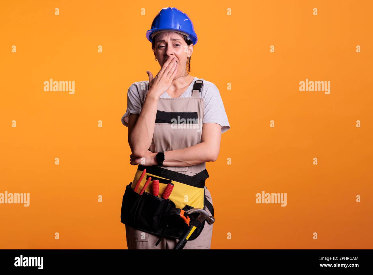 Sleepy overworked builder yawning and feeling tired, falling asleep ...