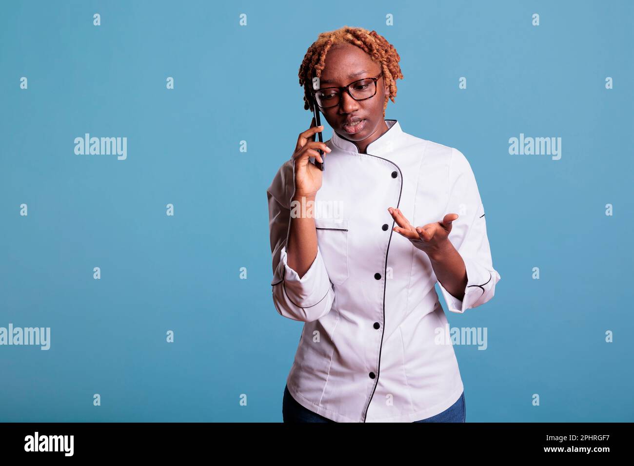 African american woman in chefs uniform having serious conversation ...