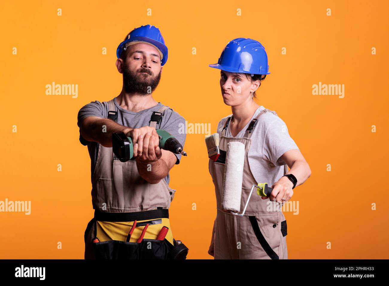 Builders posing with construction or renovation tools on camera ...