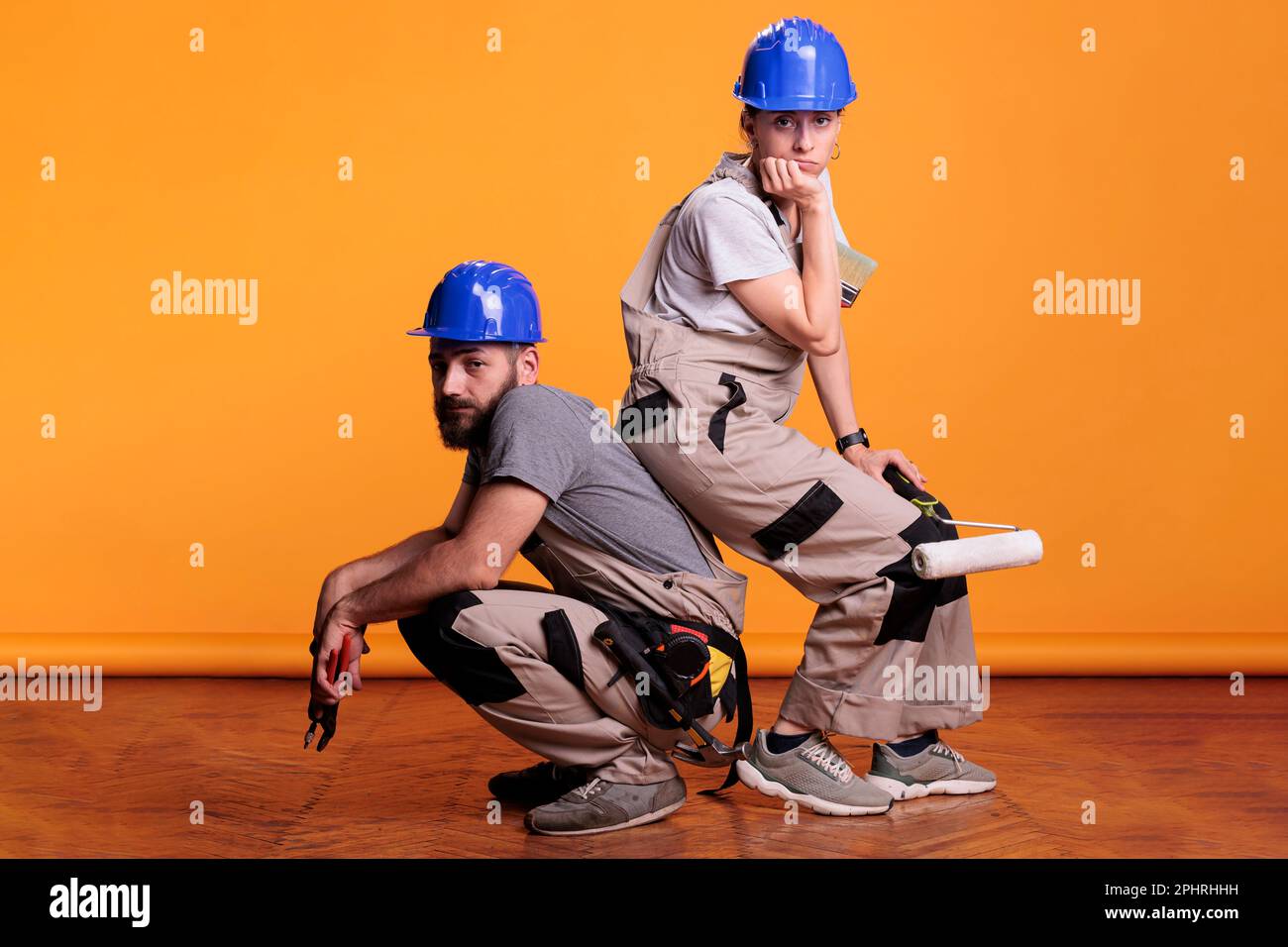 Professional carpenters holding construction tools in studio shot ...