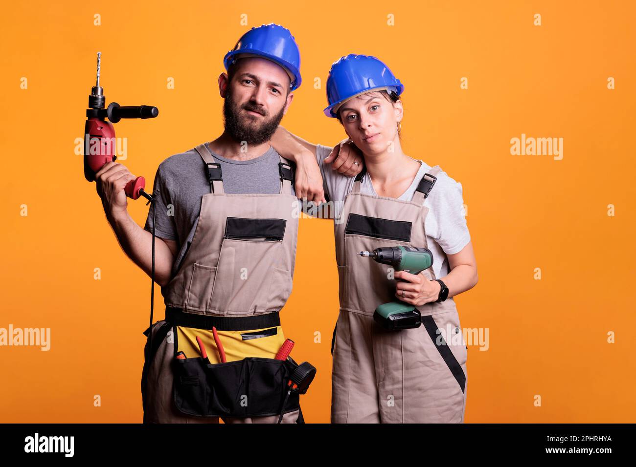 Team of professional engineers holding power drill guns in studio ...