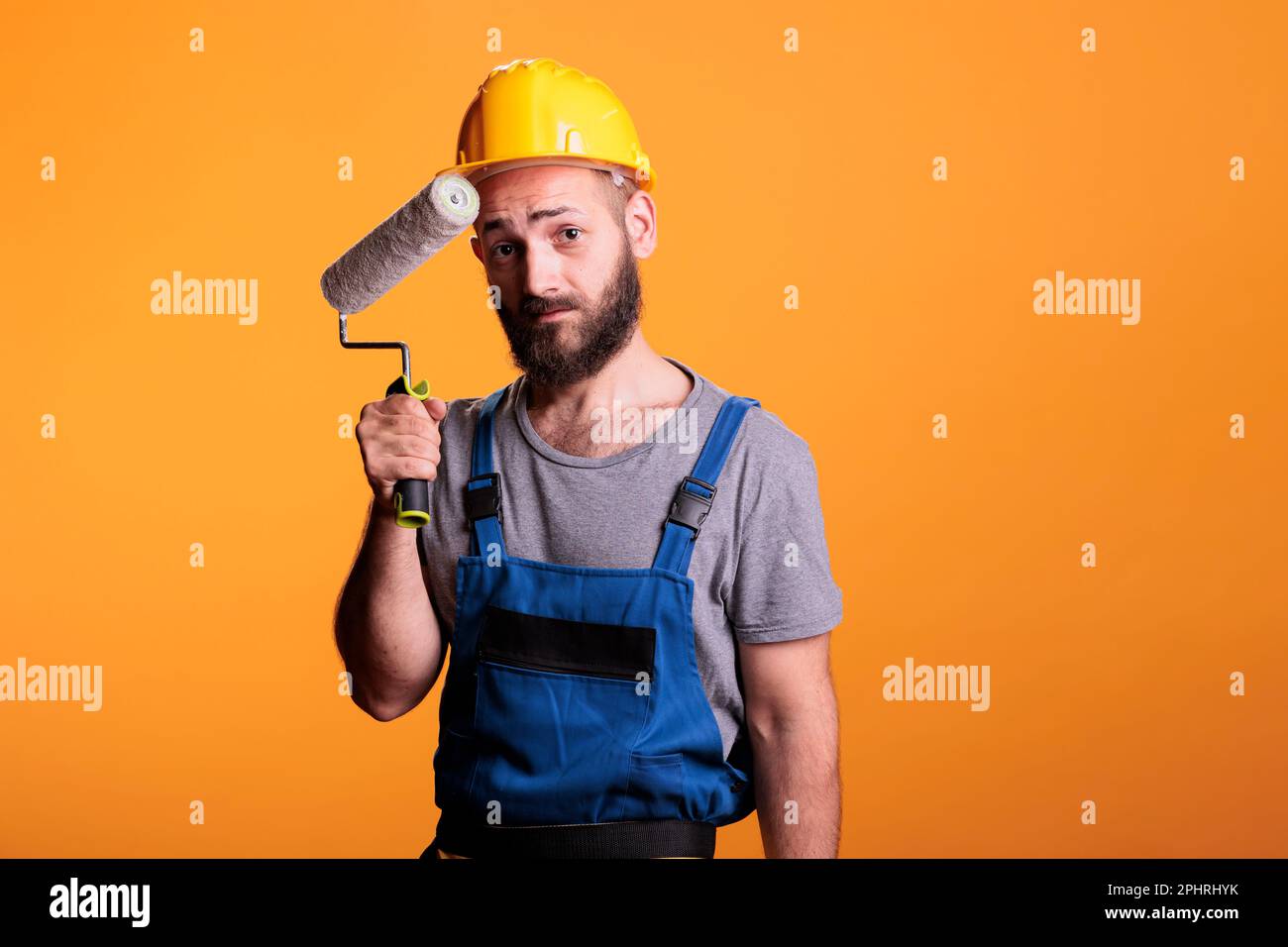 Professional painter working on renovation with roller, painting walls ...