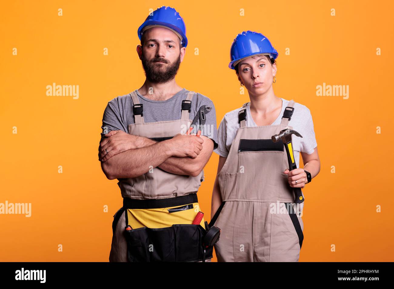 Team of building engineers holding renovating tools on camera, using ...