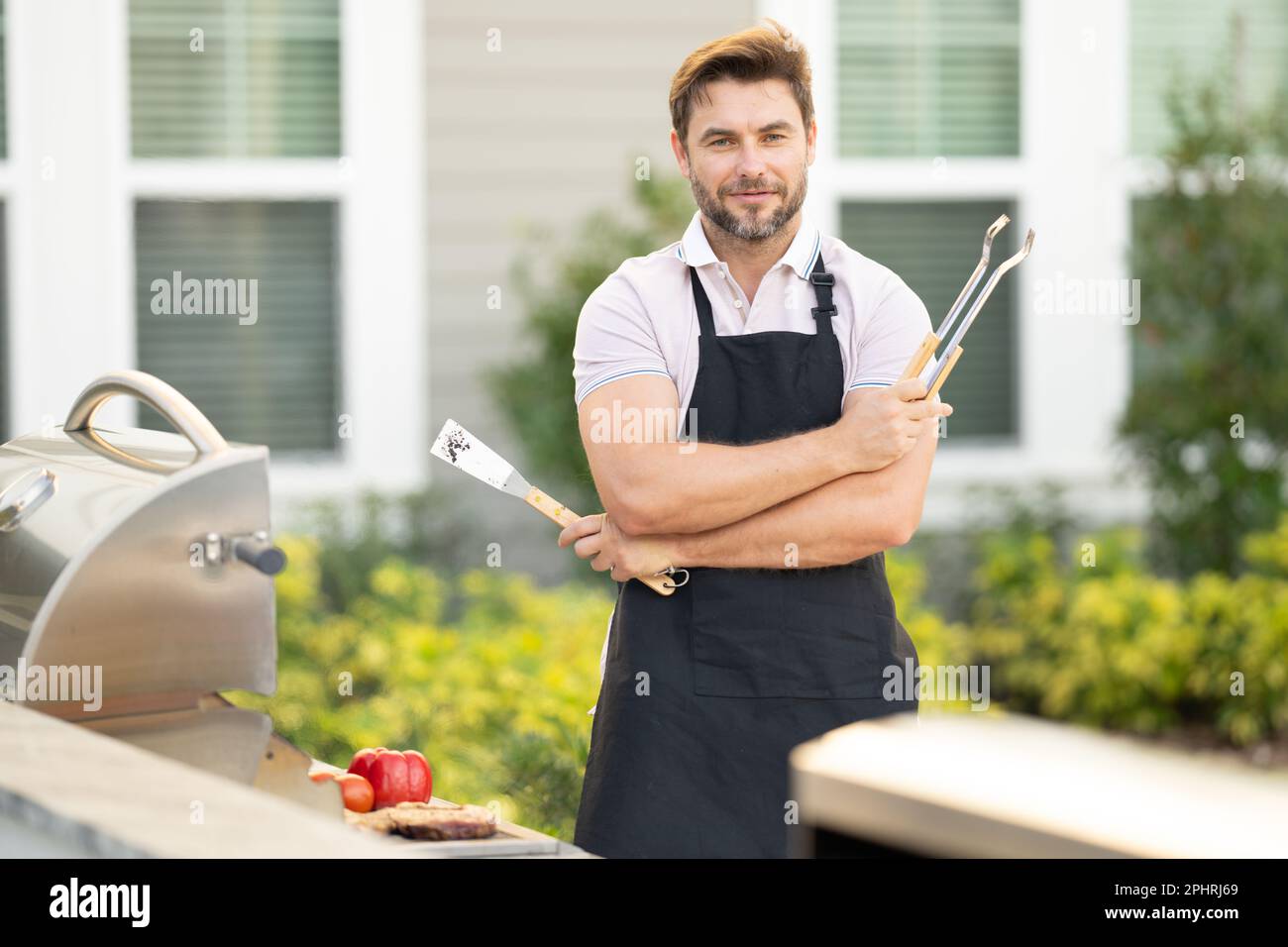 Chef preparing barbecue. Male cook cooking meat on barbecue grill. Man ...