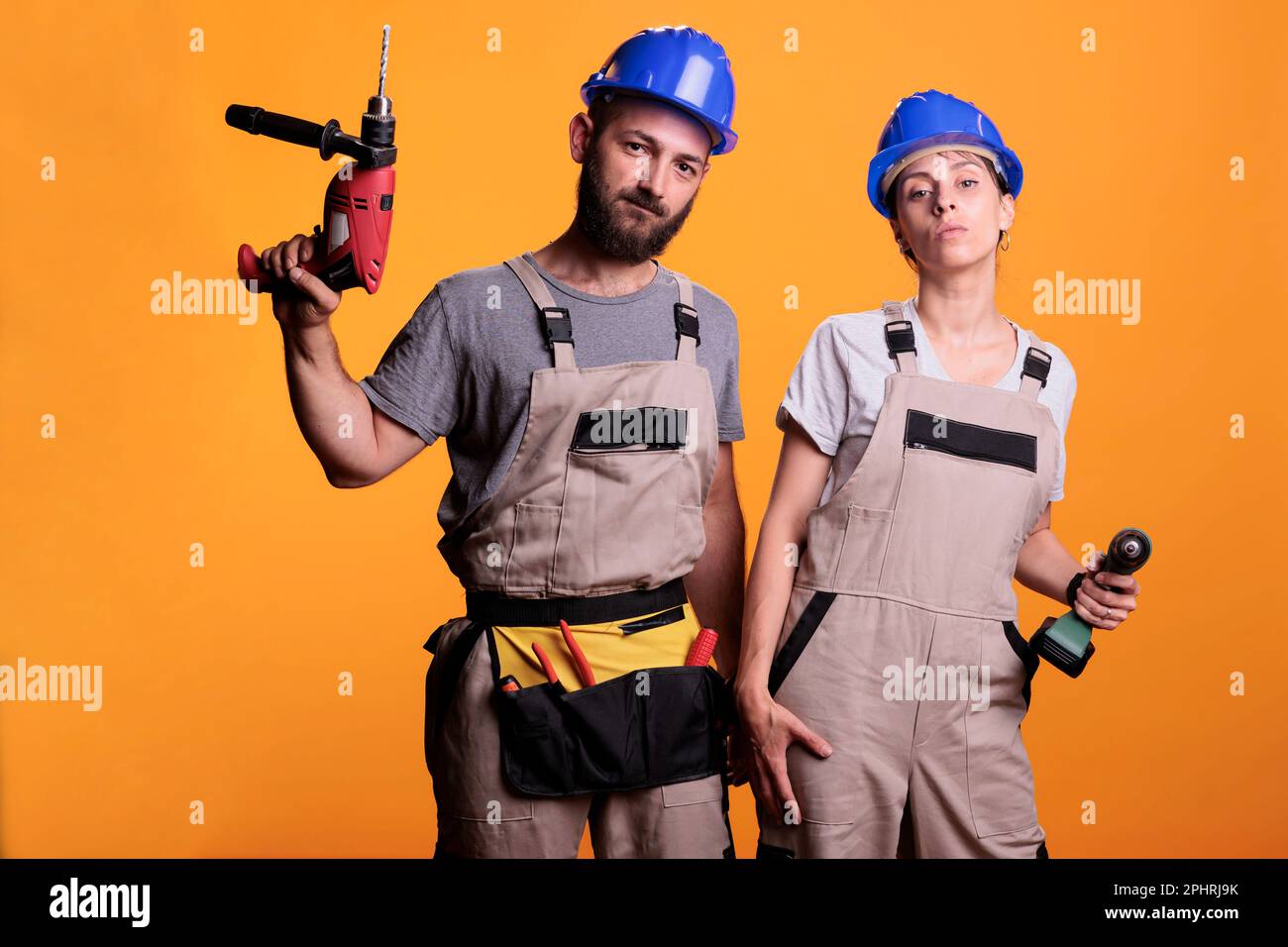 Man and woman renovators using drilling tools in studio, holding ...