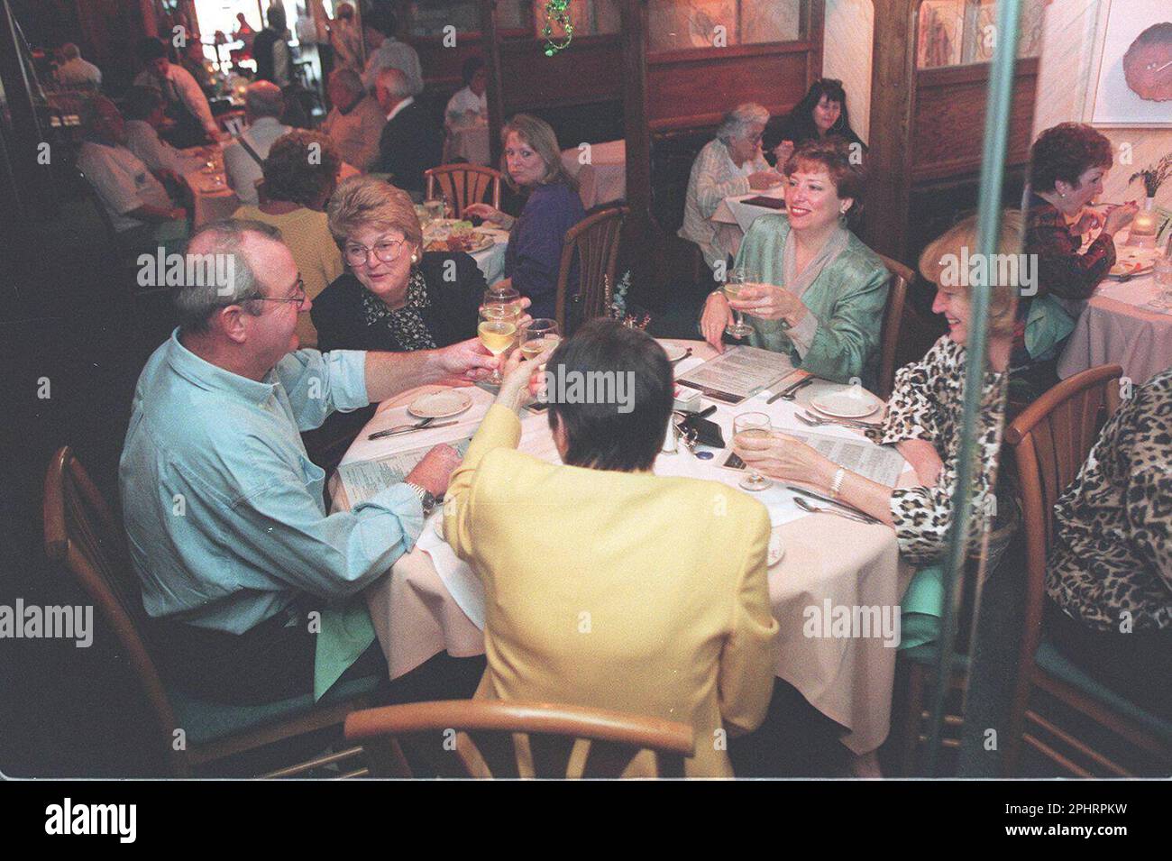 LUNCH GUESTS RAISE THEIR GLASSED FOR A BIRTHDAY TOAST IN THE DOWNSTAIRS ...